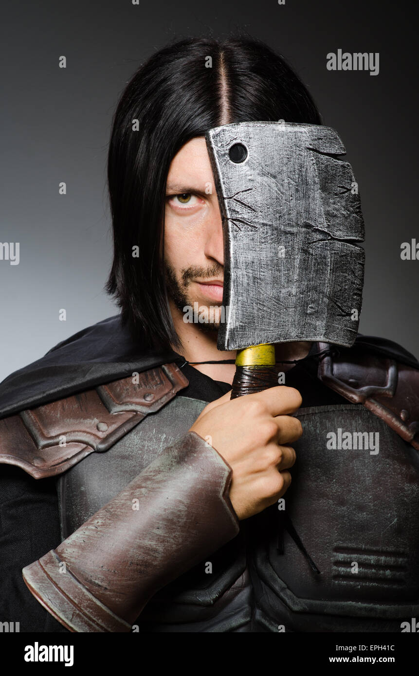 Knight with axe against dark background Stock Photo - Alamy