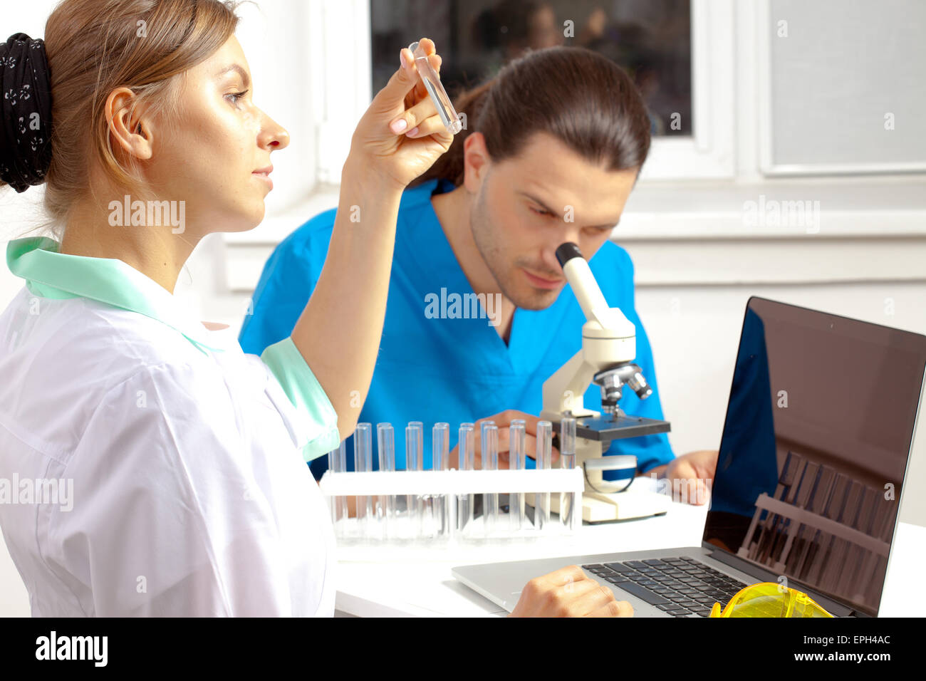 Doctor examines a test tube Stock Photo - Alamy