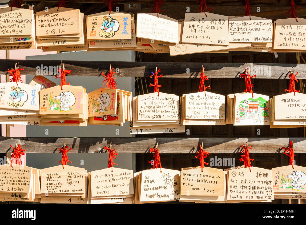 Japanese ema boards, wishing tablets, hanging from frame work by red ...