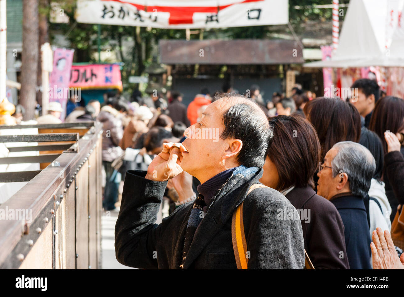 New year in Japan. Man throwing coin into the large collection box in ...