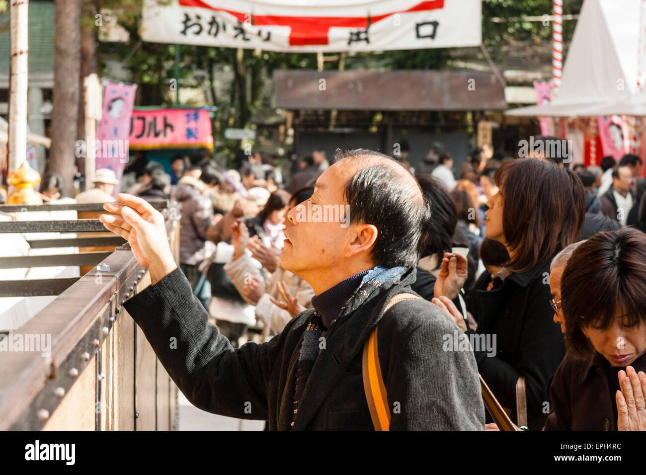 New year in Japan. Man throwing coin into the large collection box in ...
