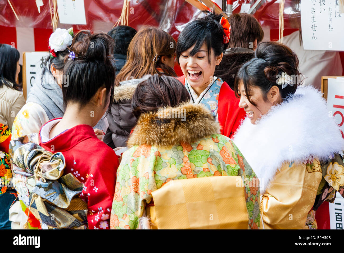Five young Japanese women dressed in kimono and fur collars, laughing ...