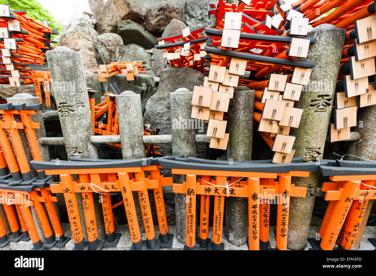Japan, Kyoto, Fushimi Inari shrine. Piles of stacked miniature ...