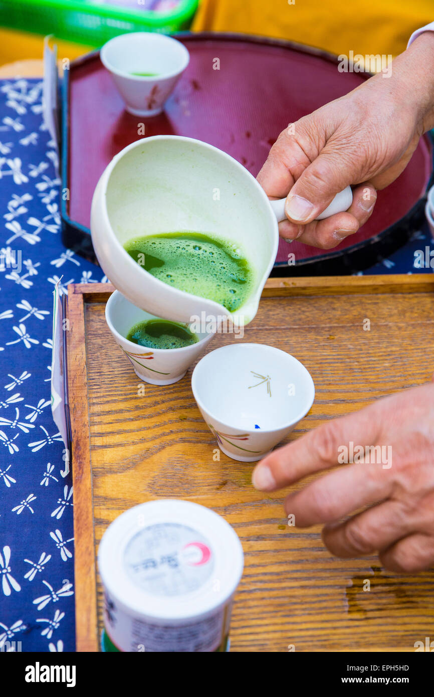making matcha green tea at a market Stock Photo - Alamy