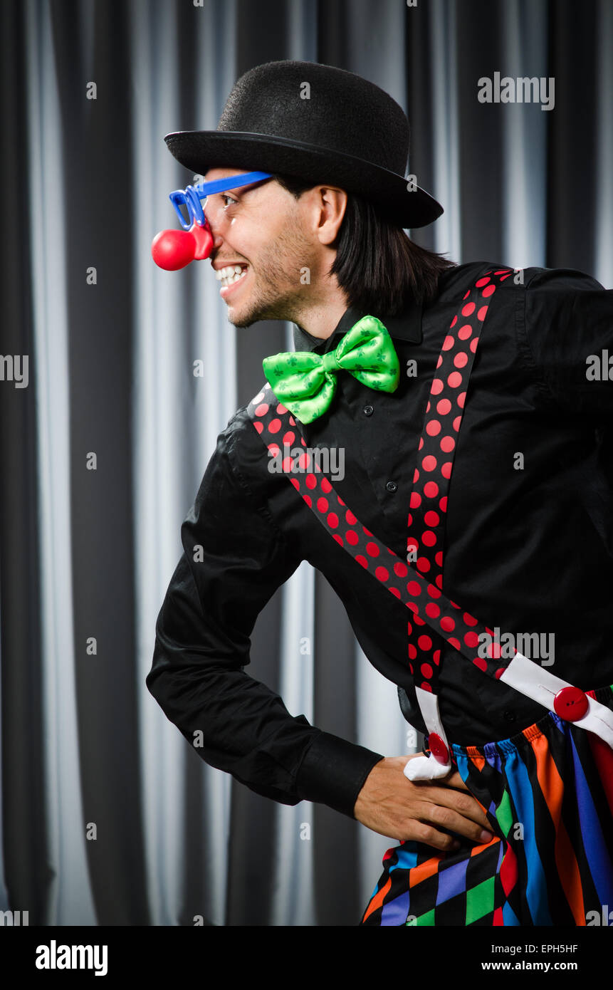 Funny clown in humorous concept against curtain Stock Photo - Alamy