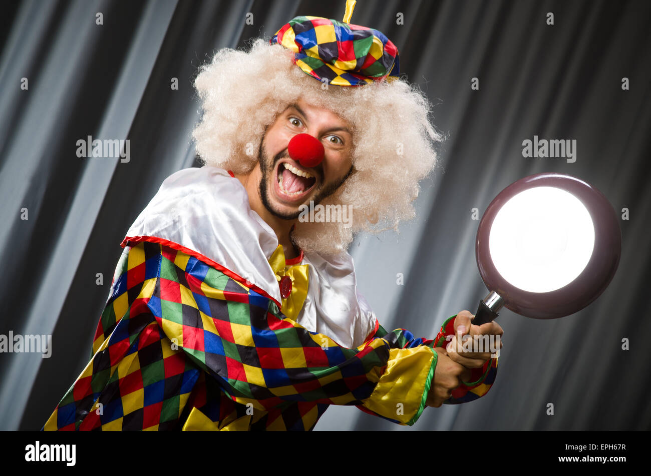 Angry clown with frying pan Stock Photo - Alamy