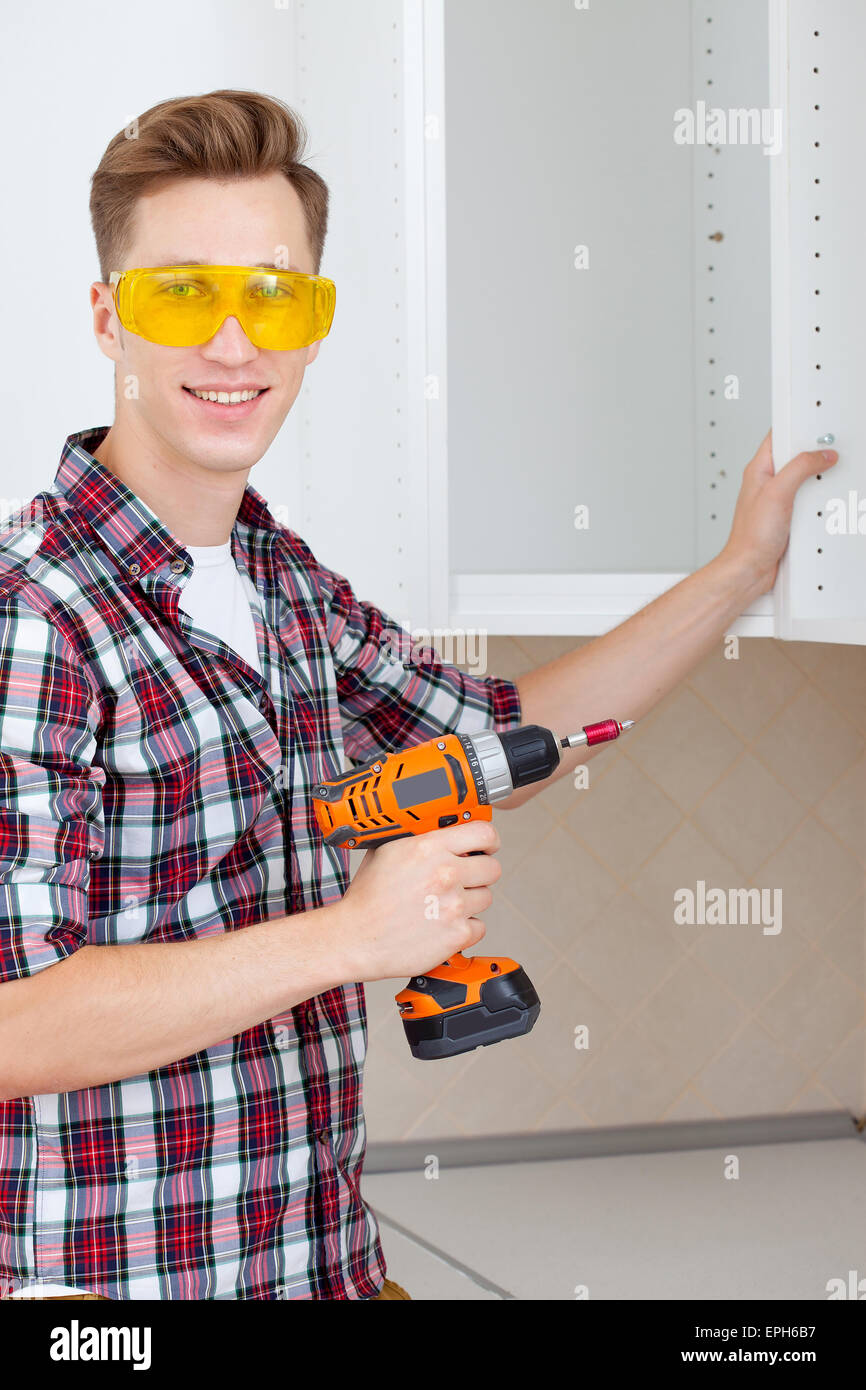Handyman holding screwdriver working hi-res stock photography and ...