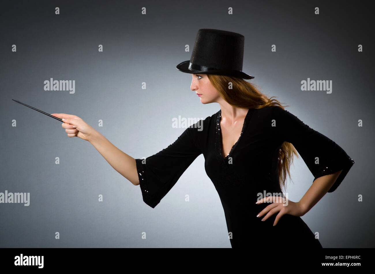Woman magician doing her tricks with wand Stock Photo - Alamy