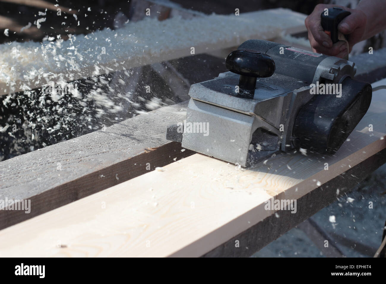 Electric hand plane during processing of boards Stock Photo - Alamy
