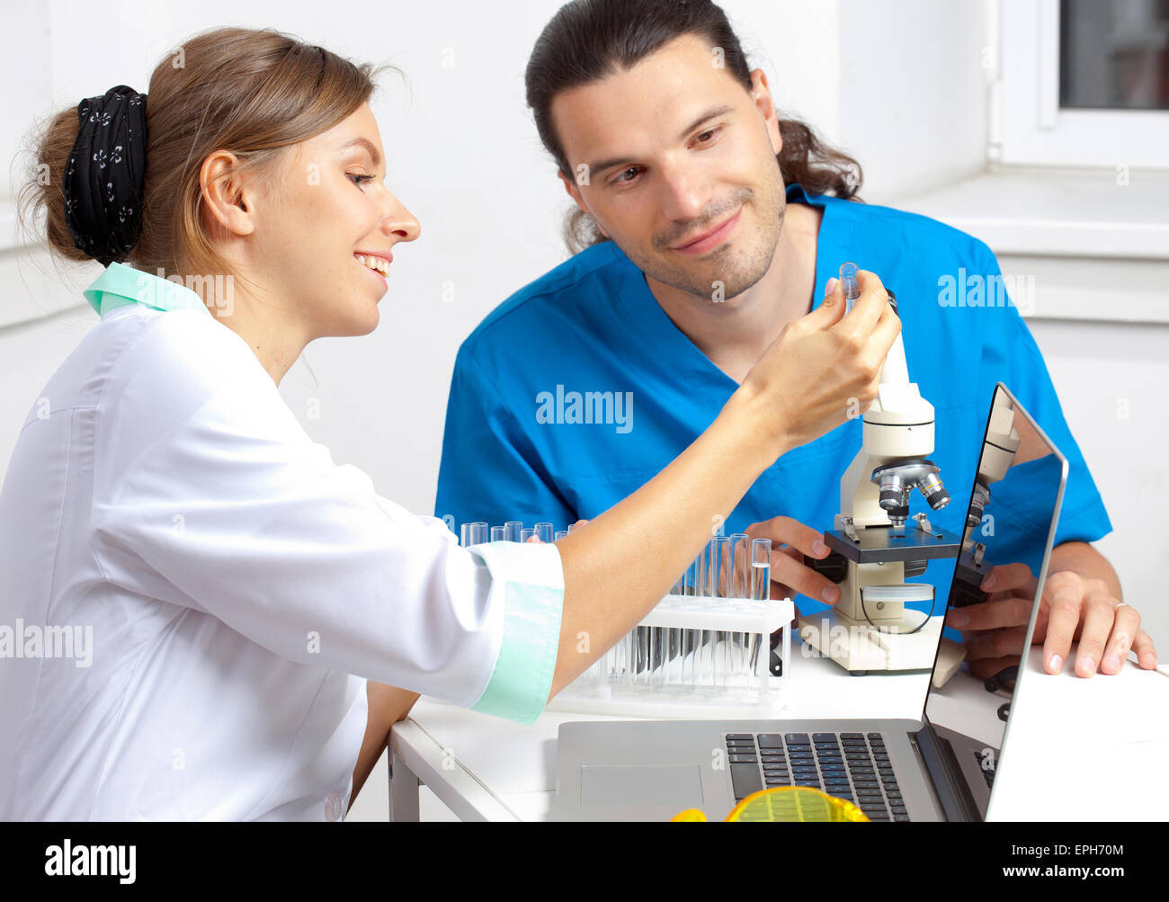 Doctor shows test tube Stock Photo - Alamy