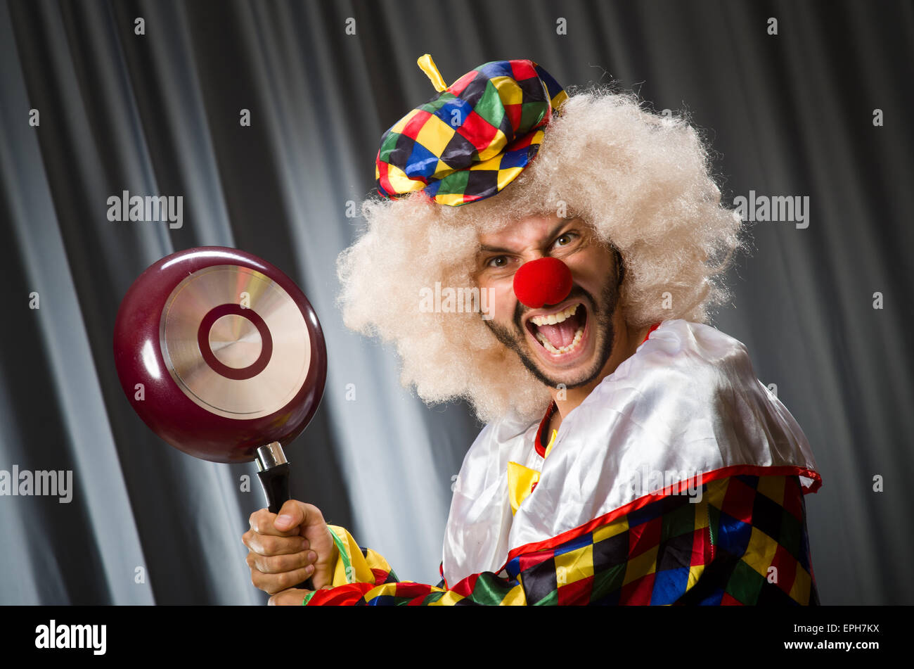 Angry clown with frying pan Stock Photo - Alamy