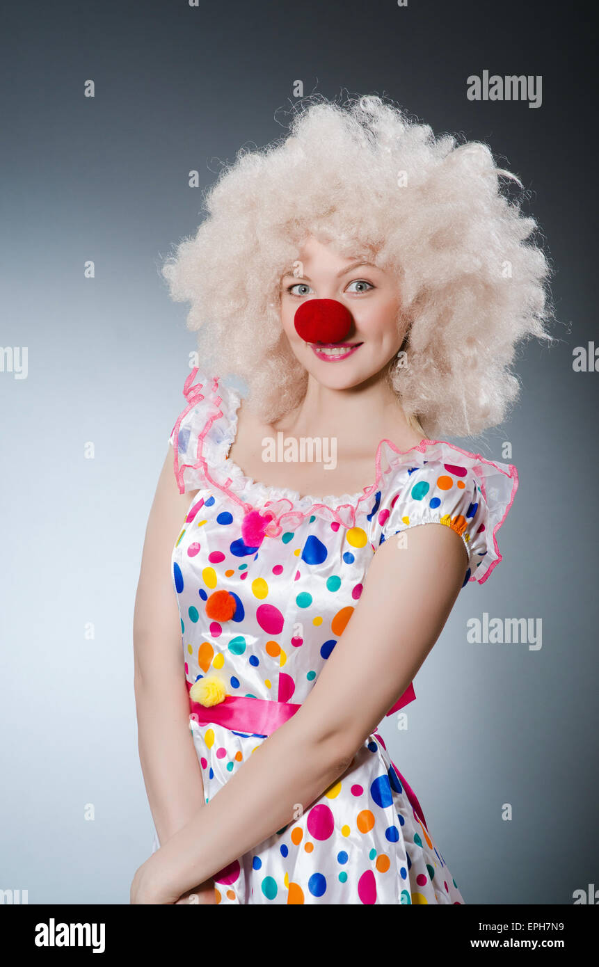 Clown with white wig against grey background Stock Photo - Alamy