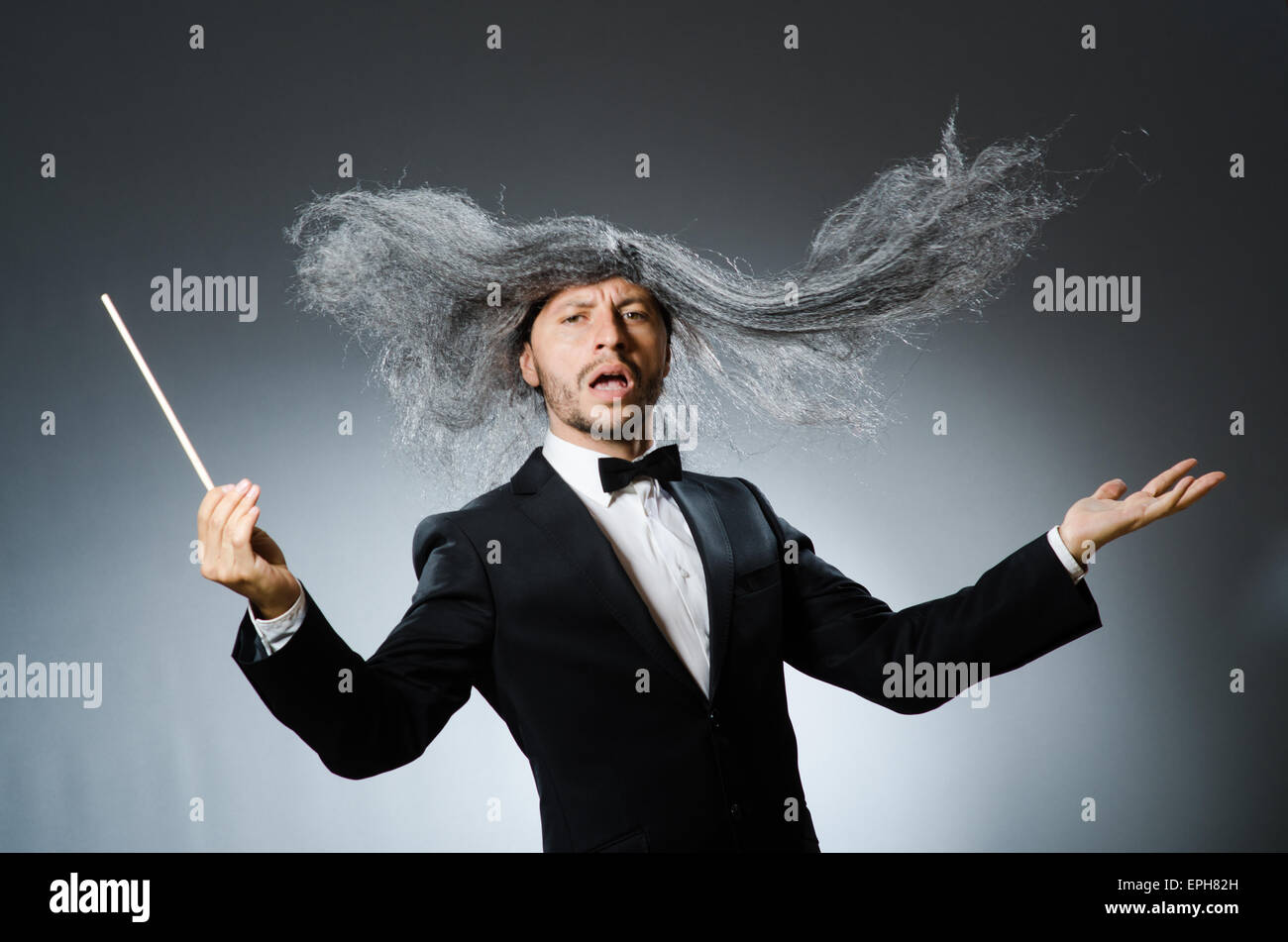 Funny conductor with long grey hair Stock Photo - Alamy
