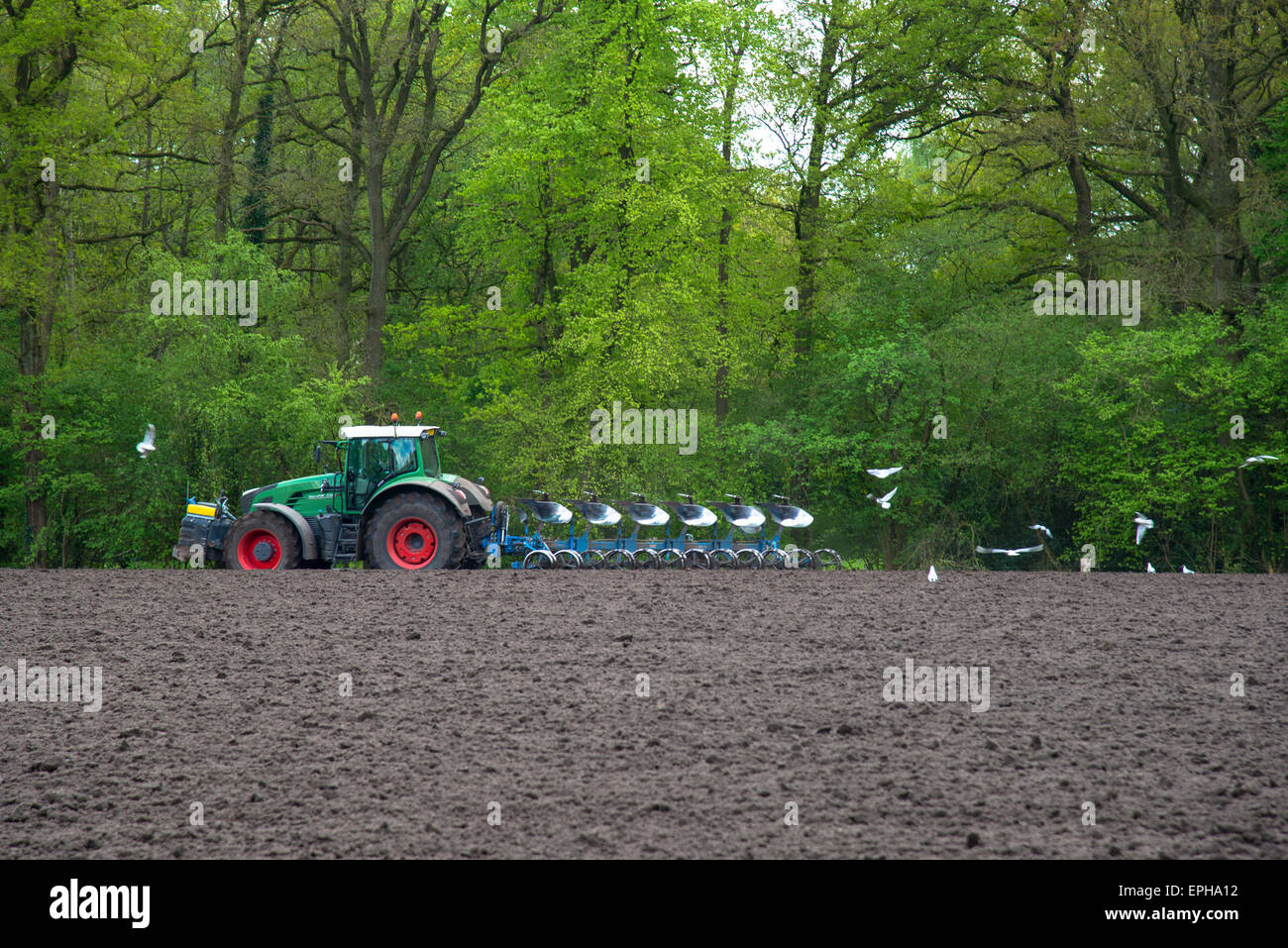 farmer with tractor plowing the field Stock Photo - Alamy