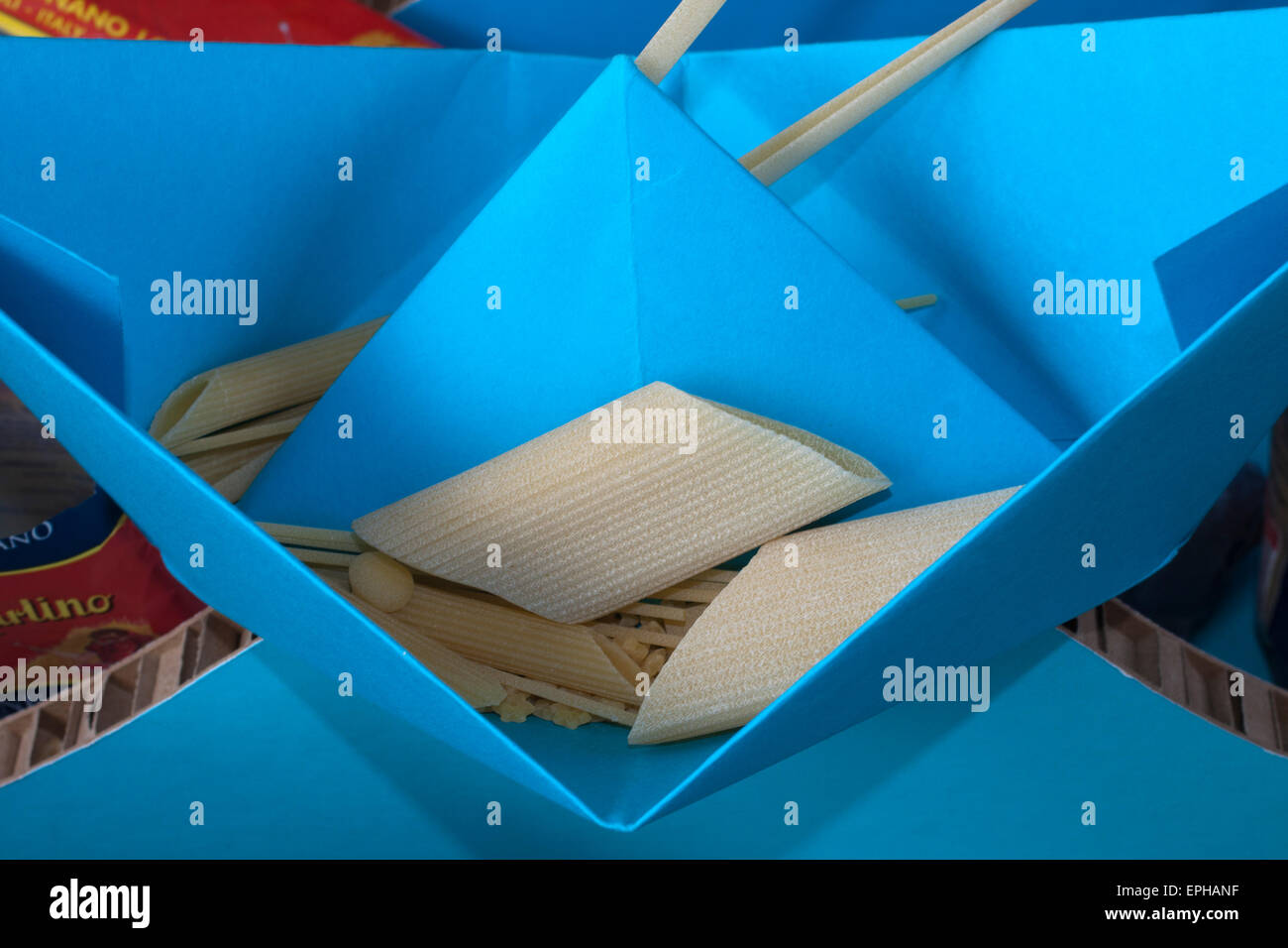 italian pasta on blue paper boat Stock Photo - Alamy