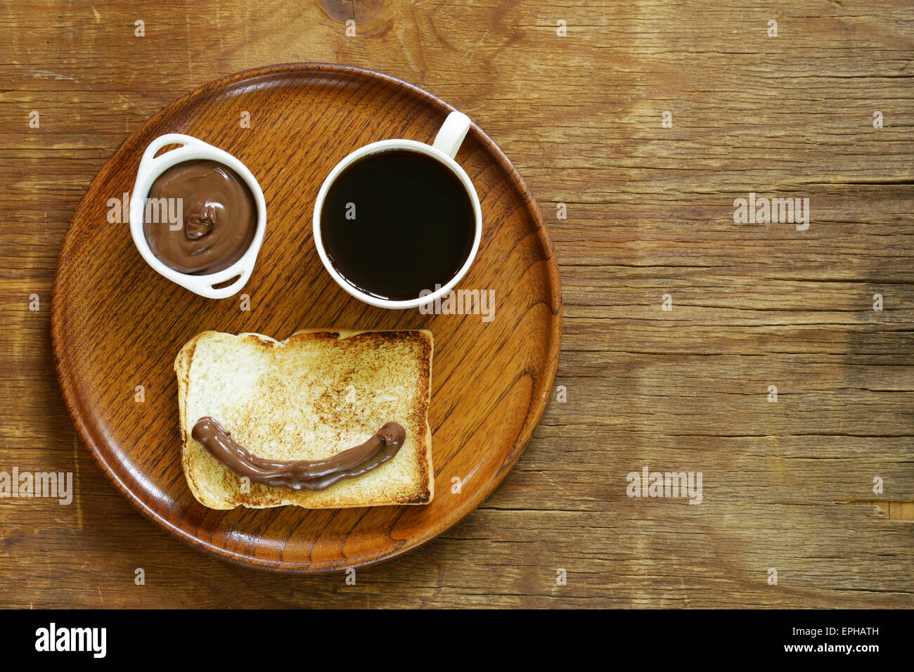 breakfast serving funny face on the plate (toast, chocolate spread and ...