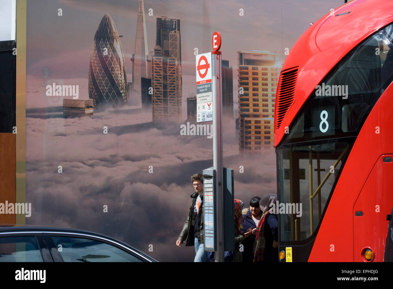 The rear of a red London Routemaster bus beneath a property developer's ...