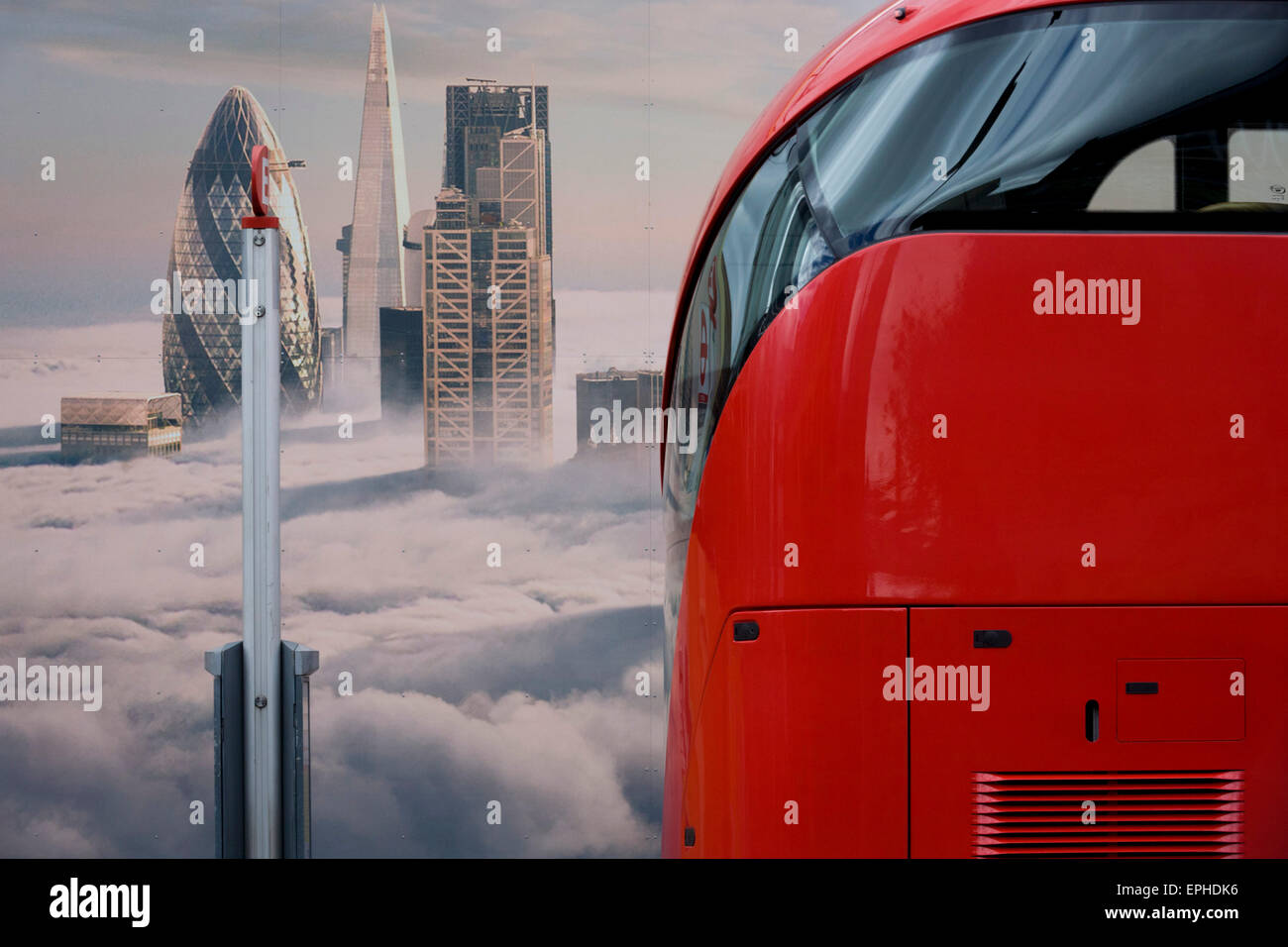 The rear of a red London Routemaster bus beneath a property developer's ...