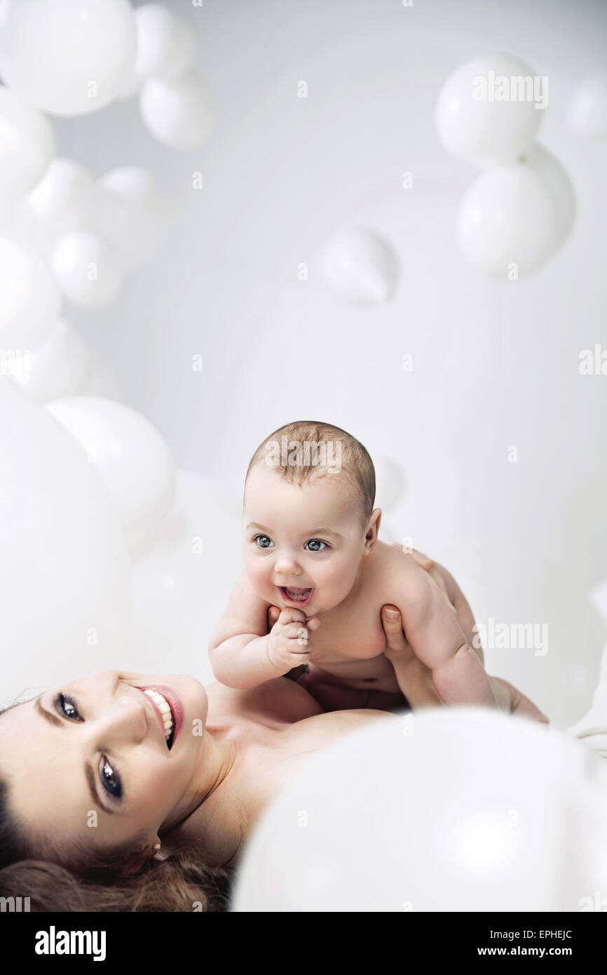 Delighted mom holding her little daughter Stock Photo - Alamy
