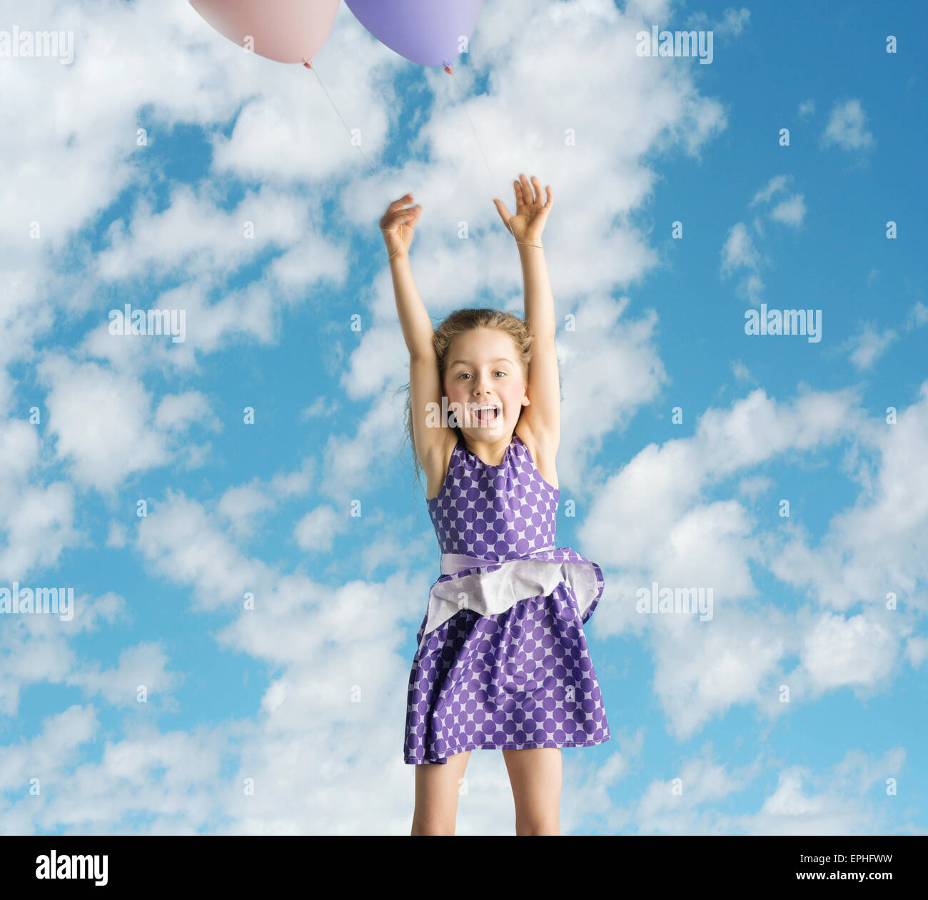 Cute little girl flying up to the sky Stock Photo - Alamy