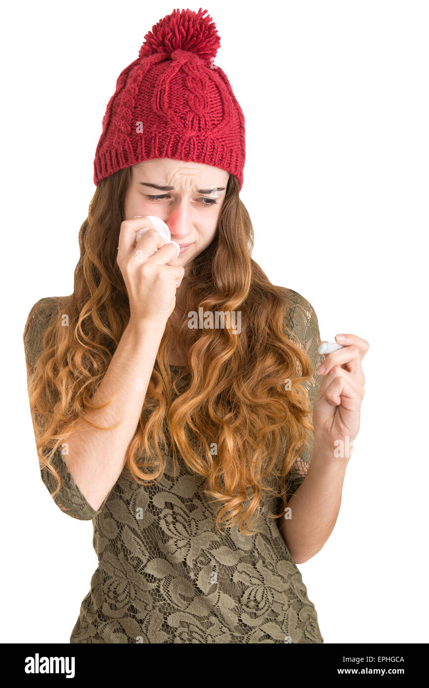 Pale sick woman with a flu checking if she has a fever with a ...