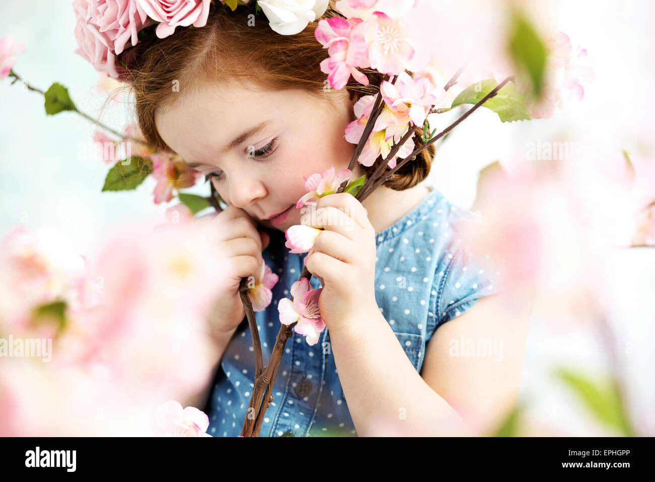 Cute little girl among fresh flowers Stock Photo - Alamy