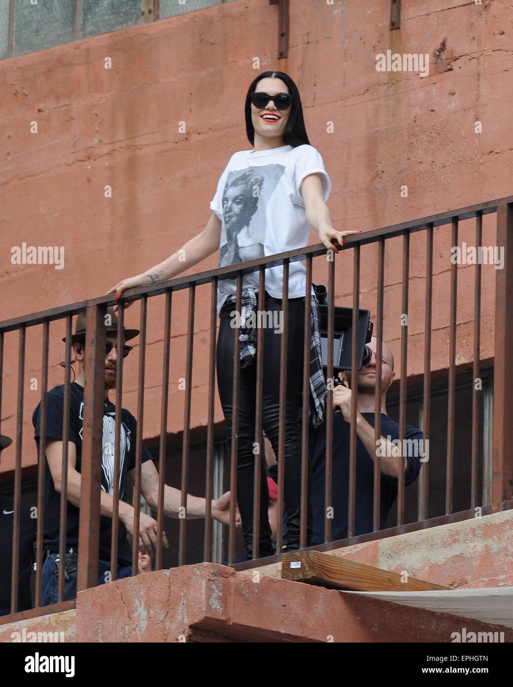 UK singer Jesse J waves at fans on a balcony while filming her latest ...