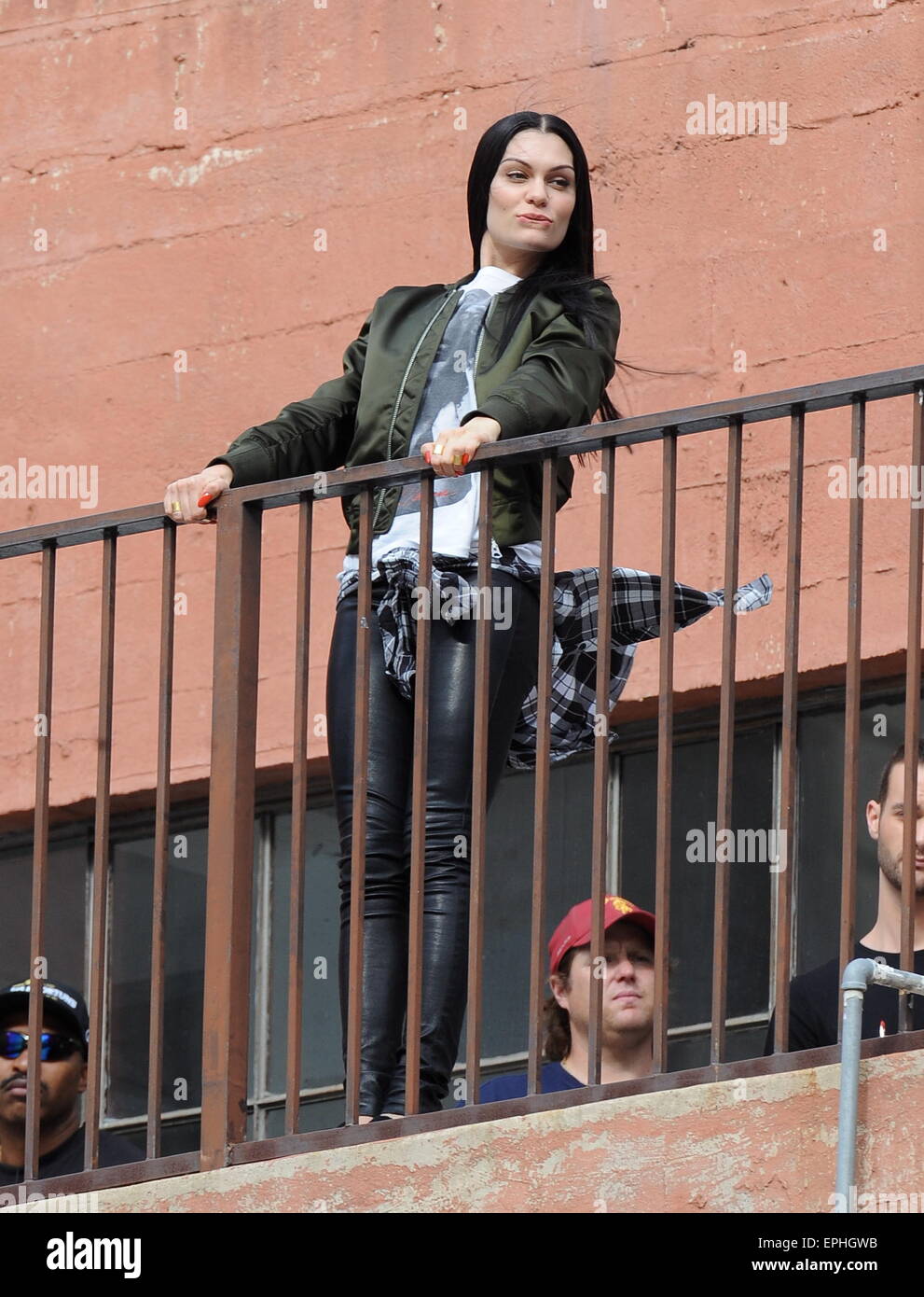 UK singer Jesse J waves at fans on a balcony while filming her latest ...