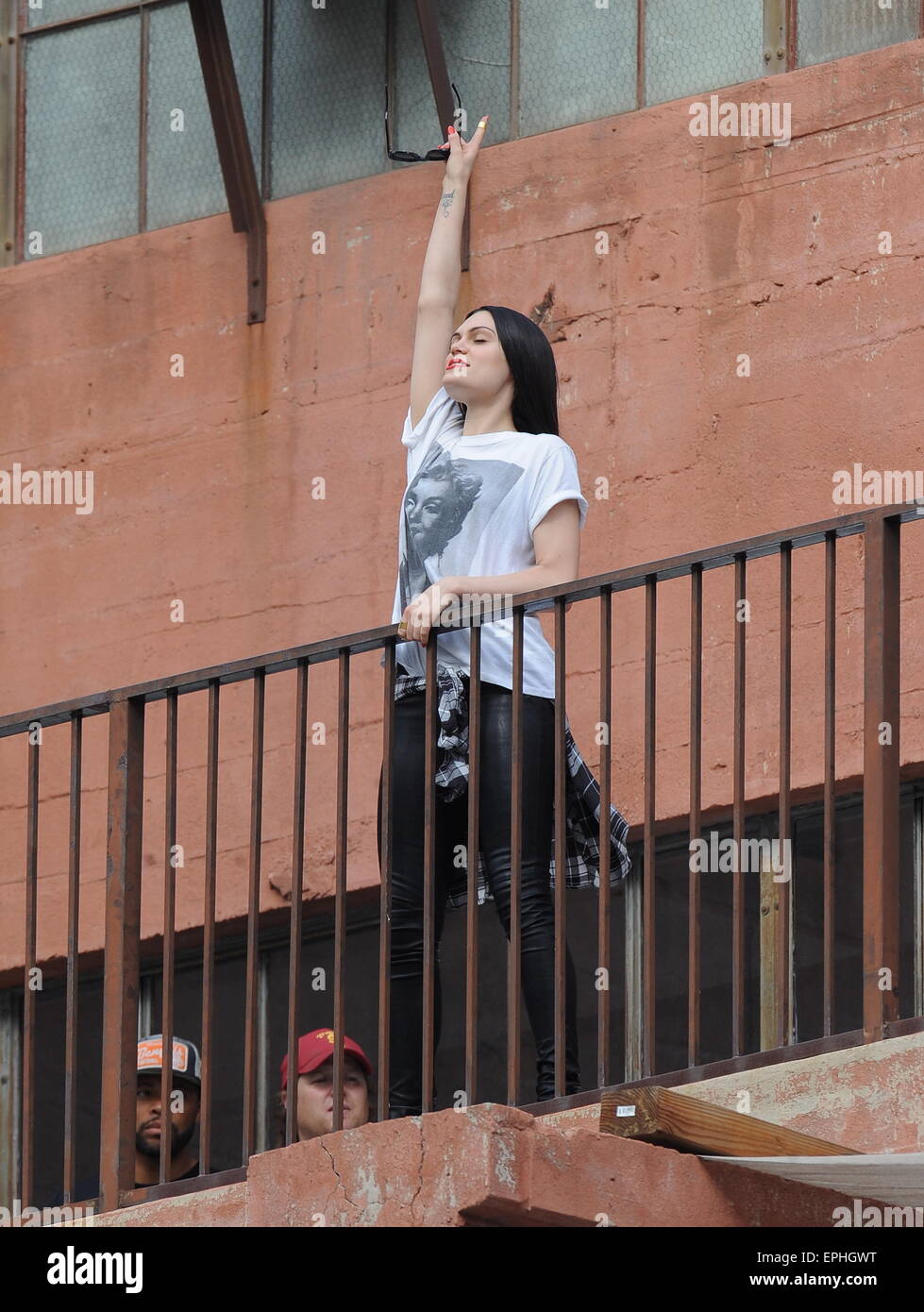 UK singer Jesse J waves at fans on a balcony while filming her latest ...