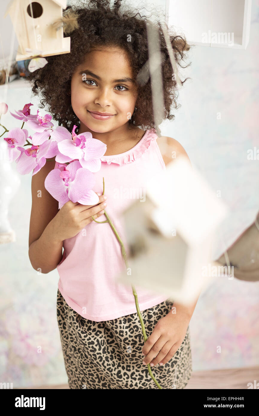 Pretty little lady holding a flower Stock Photo - Alamy