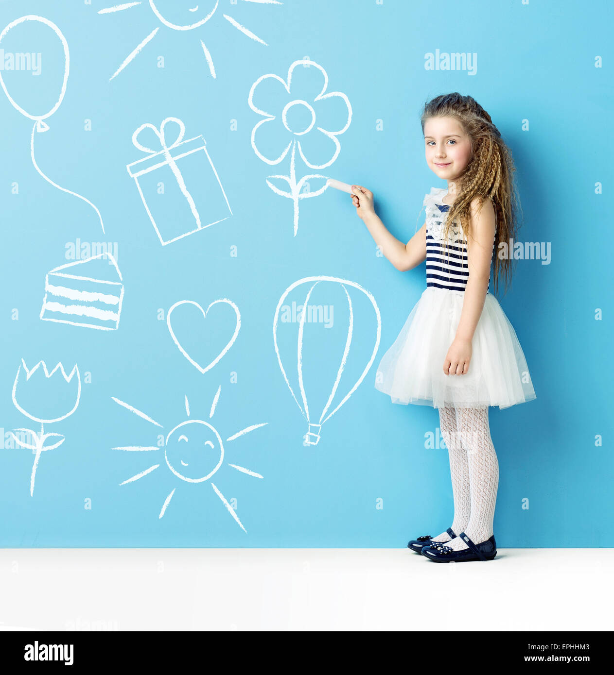 Little child making chalk drawings Stock Photo - Alamy