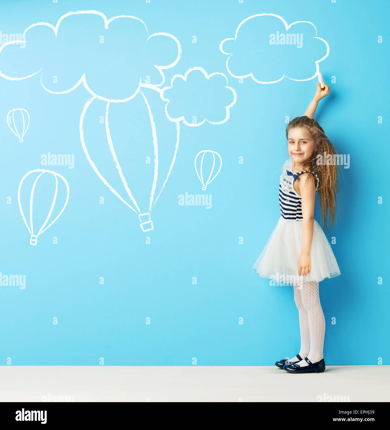 Cute child making chalk drawings Stock Photo - Alamy