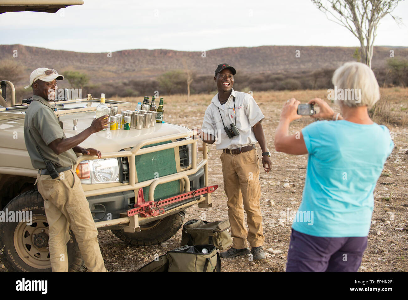 Africa, Namibia. AfriCat Foundation. Tourist taking photograph of tour ...