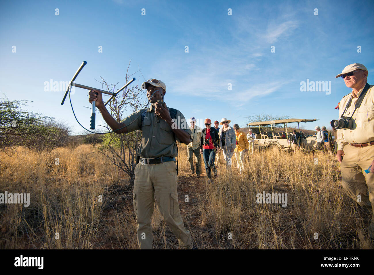 Africa, Namibia. AfriCat Foundation. Tour guide using device Stock ...