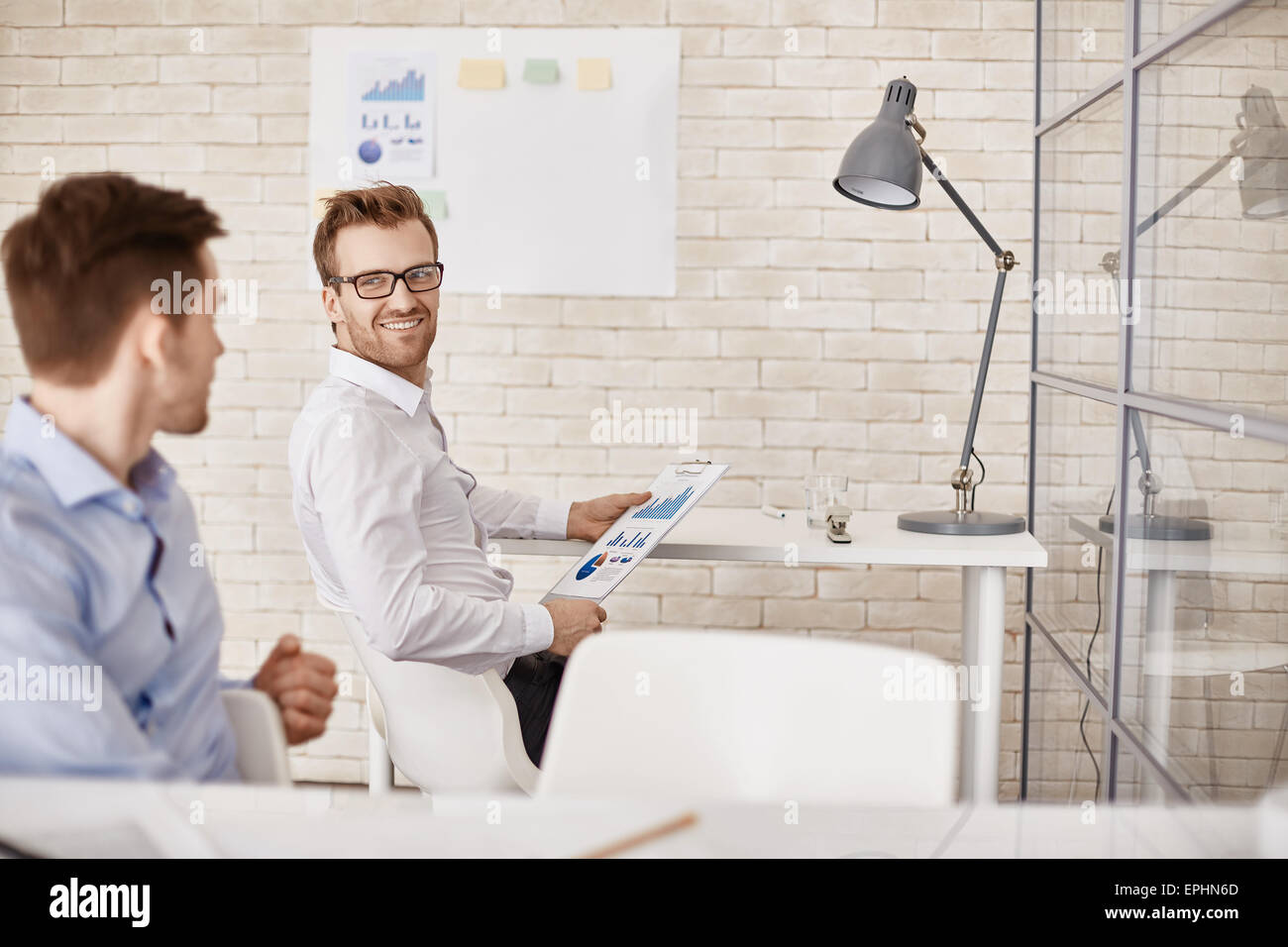 Successful businessman listening to colleague in office Stock Photo - Alamy