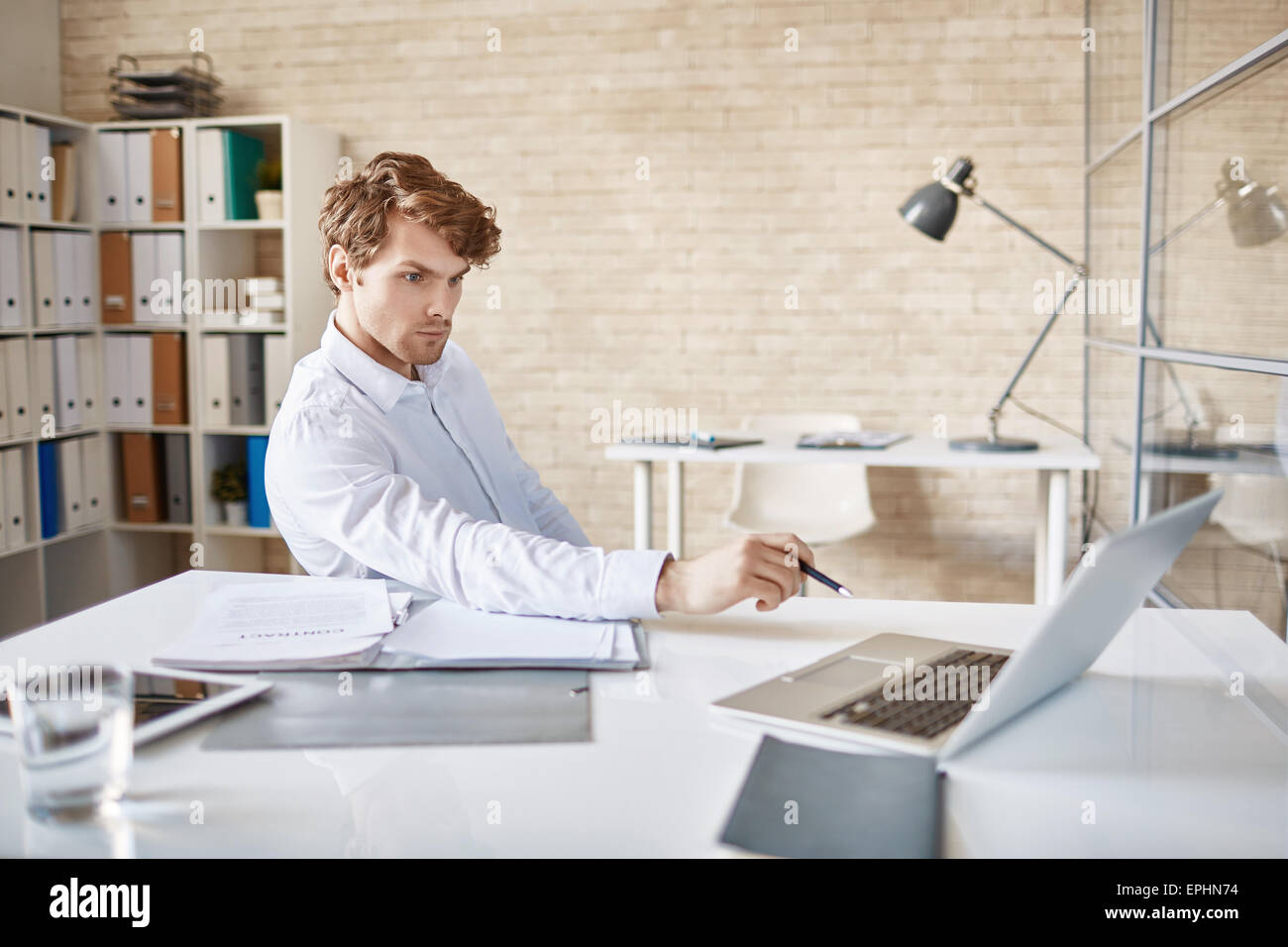 Businessman networking at workplace in office Stock Photo - Alamy