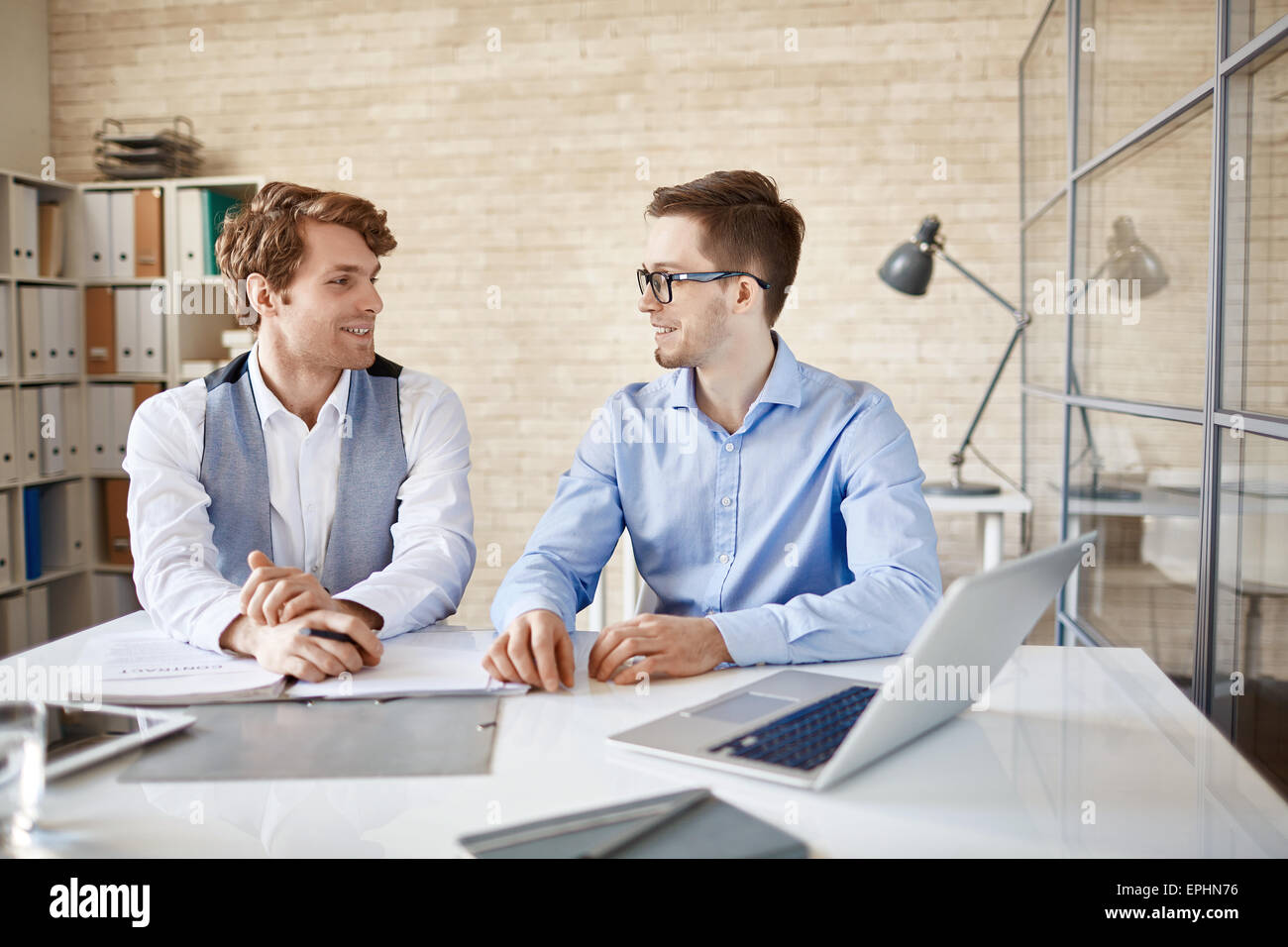Two employees discussing data in office Stock Photo - Alamy