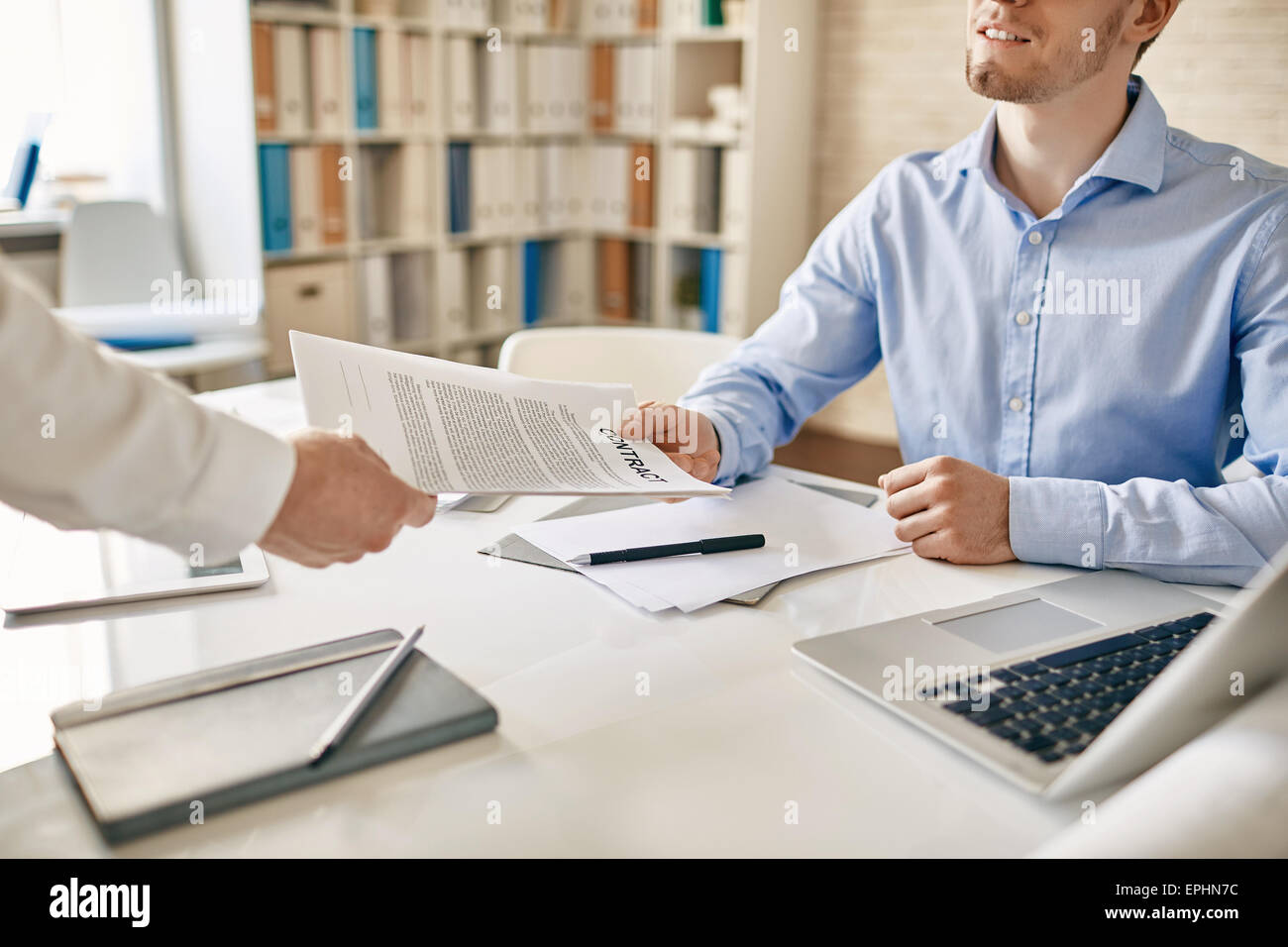 Businessman his colleague giving contract to read and sign Stock Photo ...
