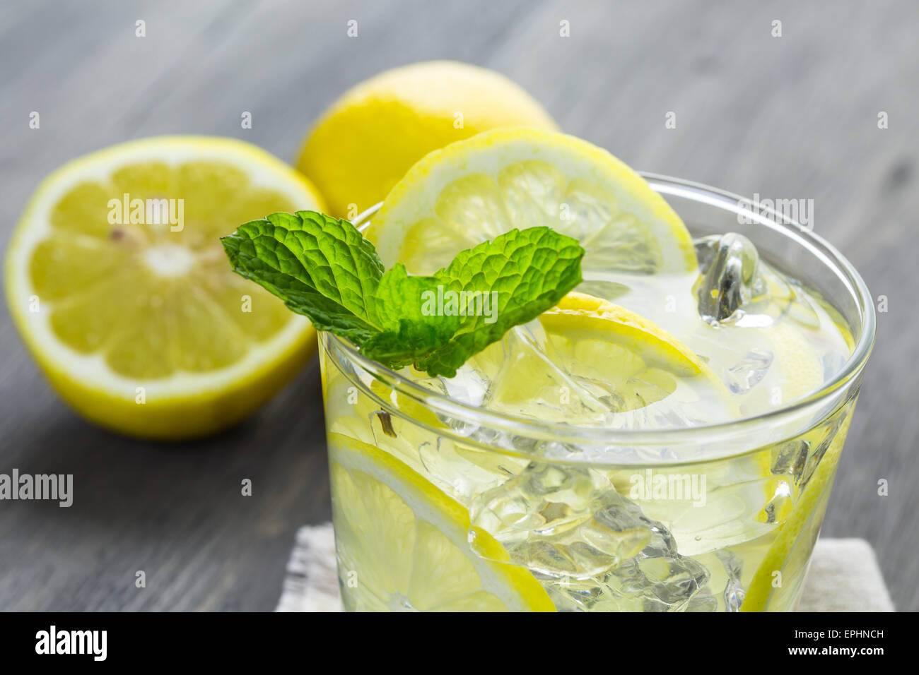 Infused water with fresh citrus fruits and ice Stock Photo - Alamy