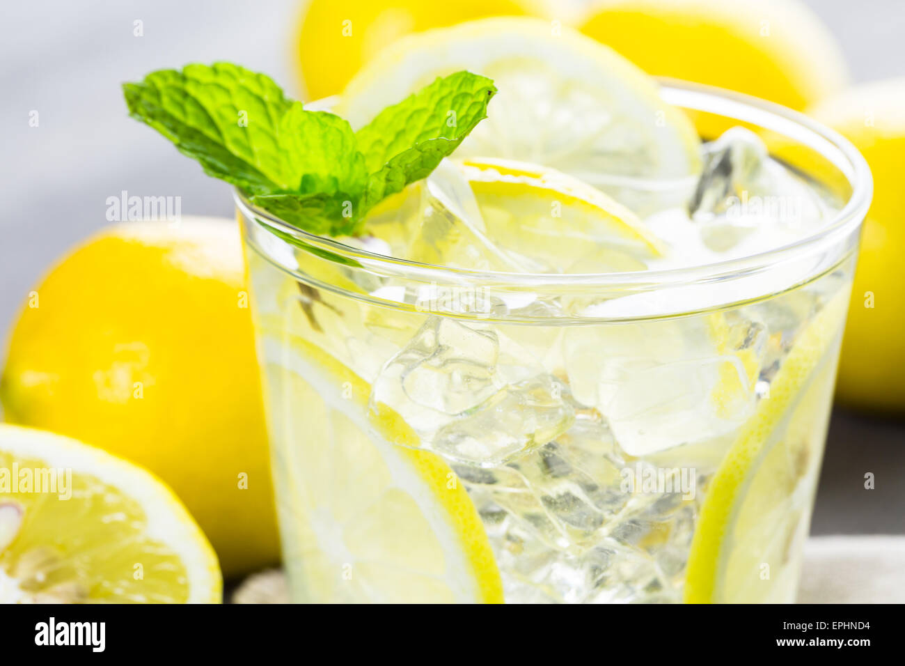 Infused water with fresh citrus fruits and ice Stock Photo - Alamy