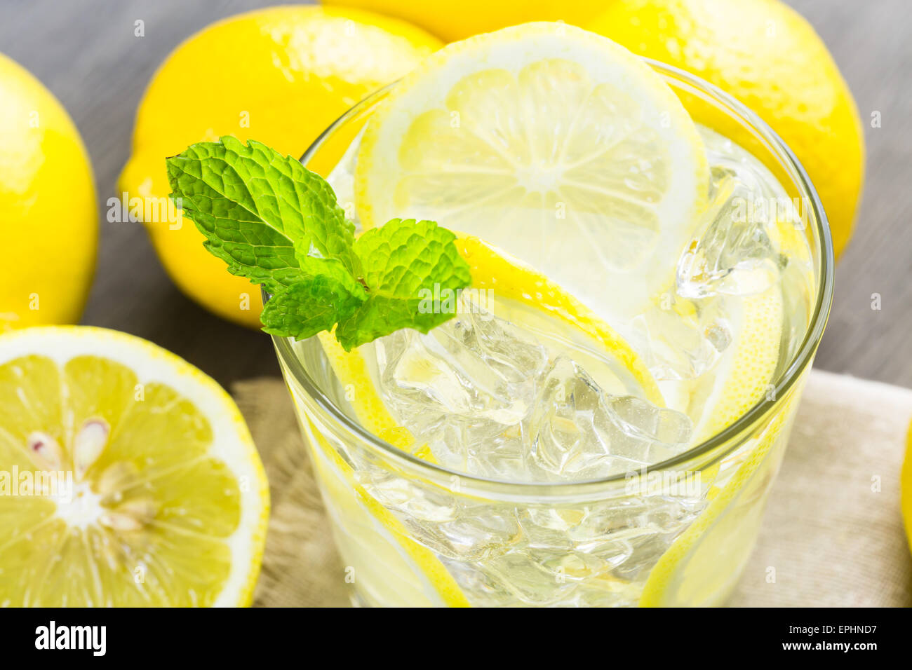 Infused water with fresh citrus fruits and ice Stock Photo - Alamy
