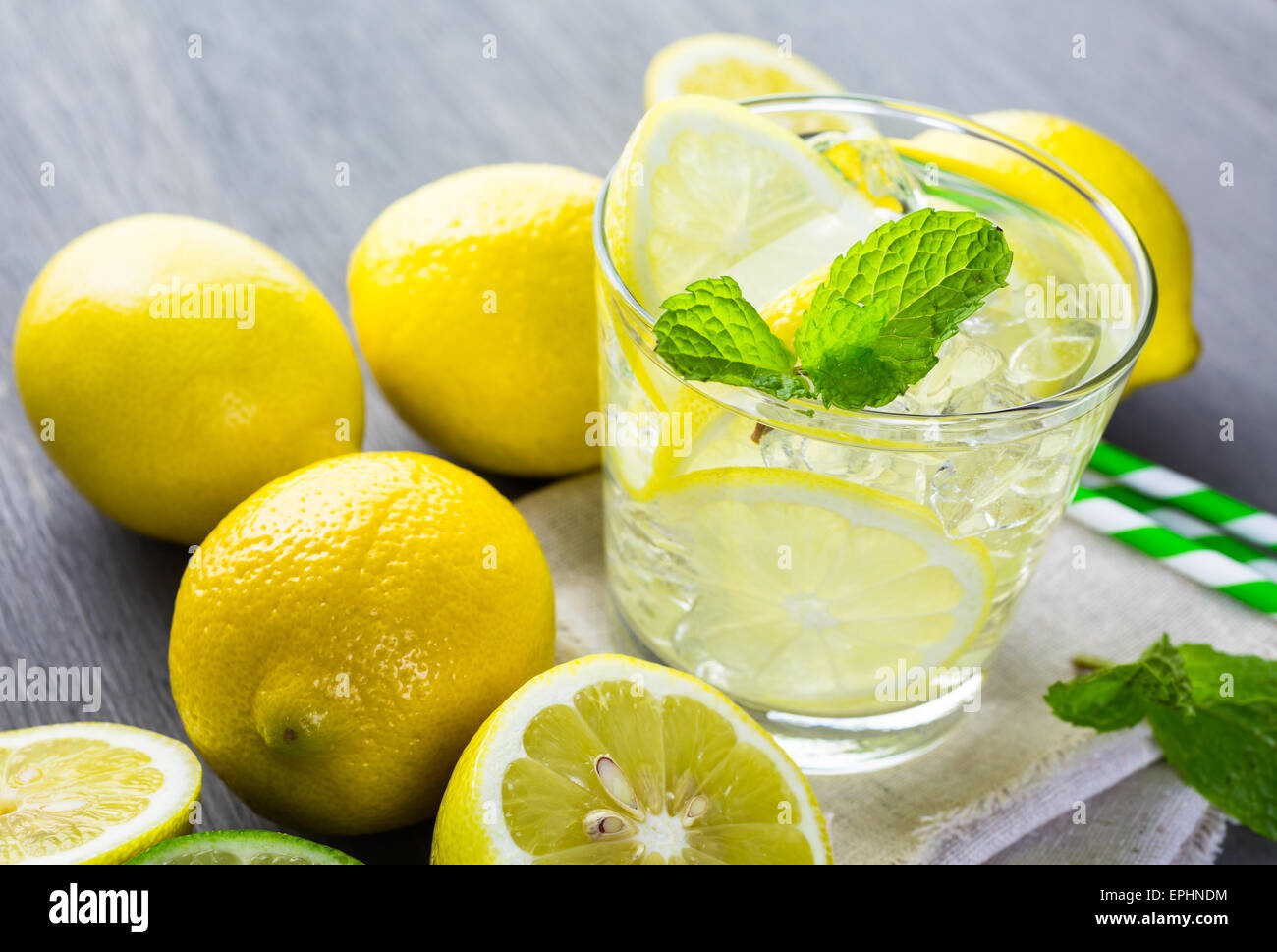 Infused water with fresh citrus fruits and ice Stock Photo - Alamy