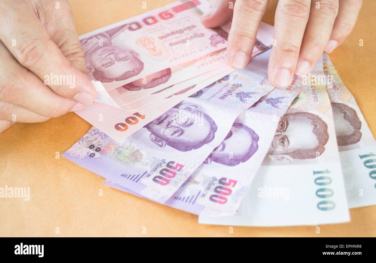 Man hand counting Thai baht banknote, stock photo Stock Photo - Alamy
