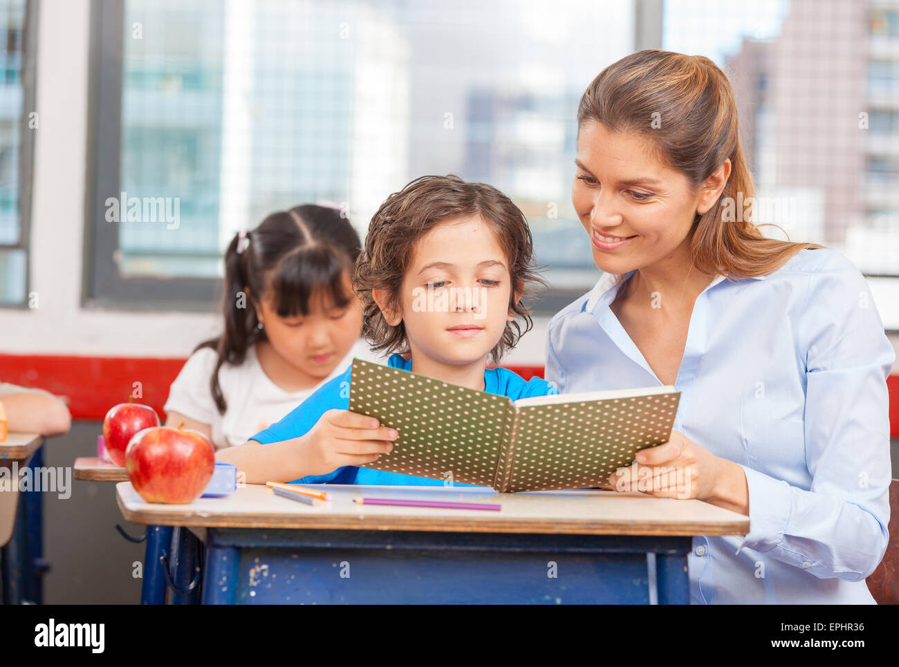 Teacher and multi race classroom having fun during a lesson Stock Photo ...