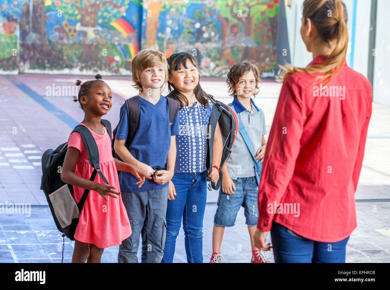 Teacher and multi race classroom having fun during a lesson Stock Photo ...