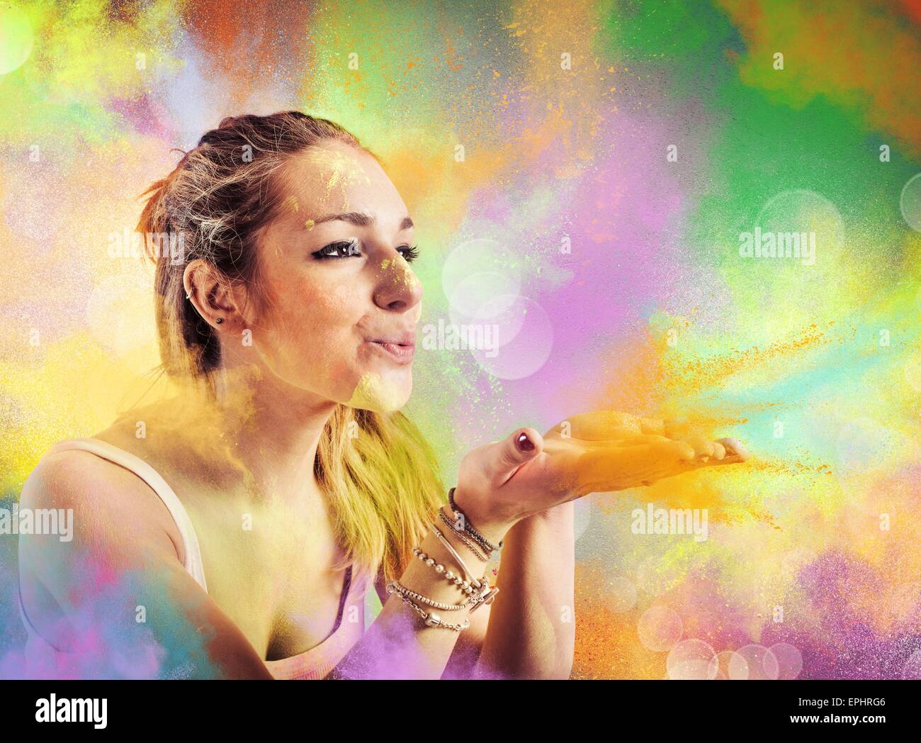 Girl blowing colored powders Stock Photo - Alamy