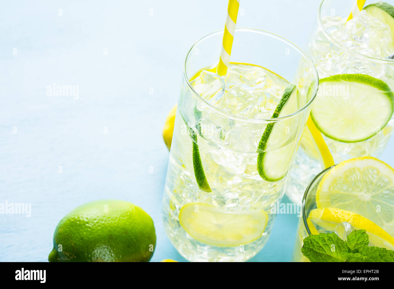 Infused water with fresh citrus fruits and ice Stock Photo - Alamy