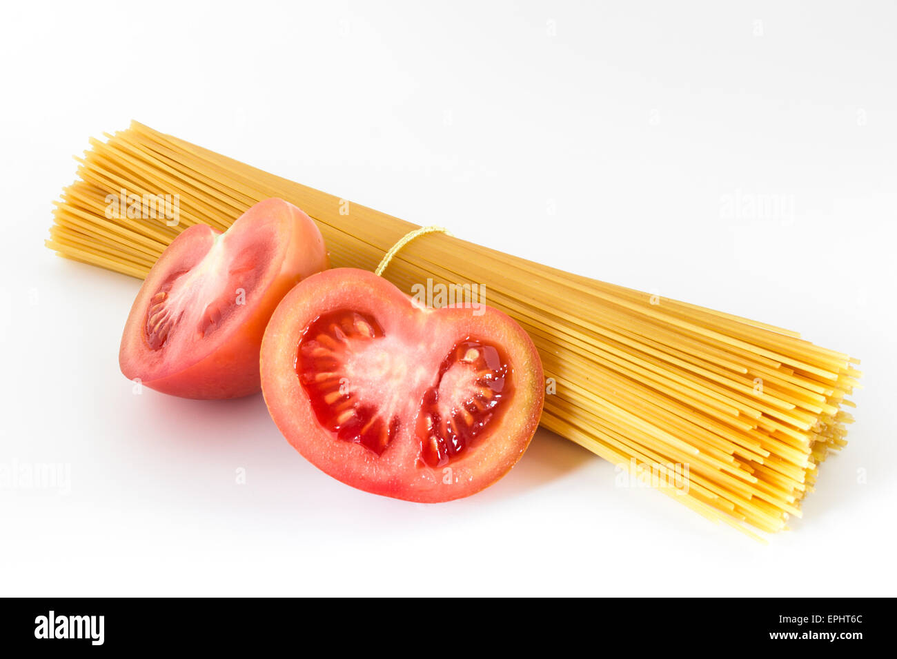Bunch of spaghetti with tomato cut in half, on a white background Stock ...