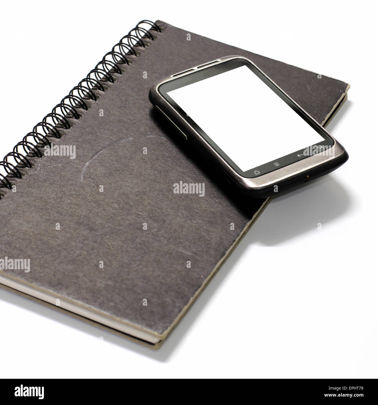 smartphone on note book on a white background Stock Photo - Alamy
