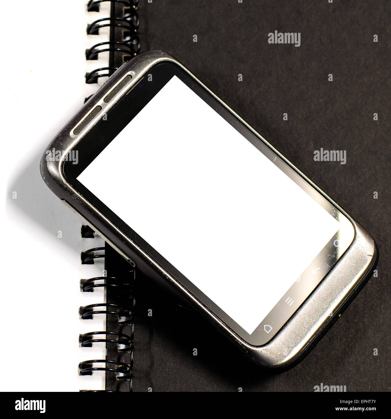 smartphone on note book on a white background Stock Photo - Alamy